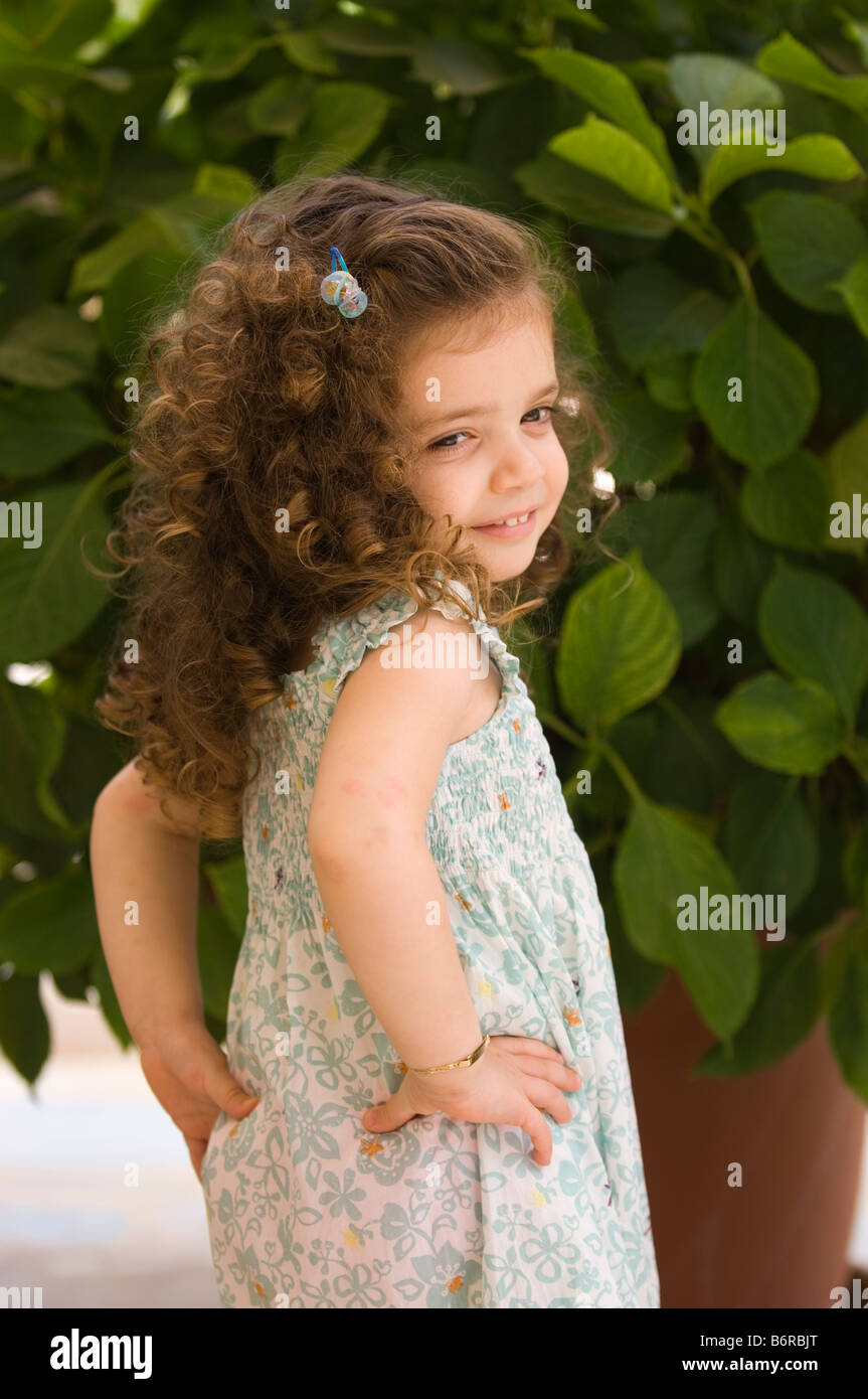 beautiful girl looking over shoulders hands on hips Stock Photo - Alamy