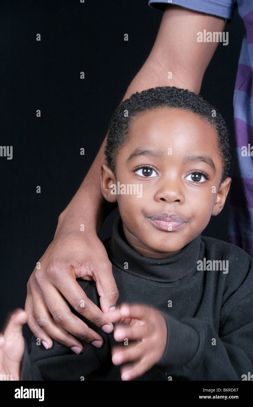 African American boy being guided by his father Stock Photo - Alamy