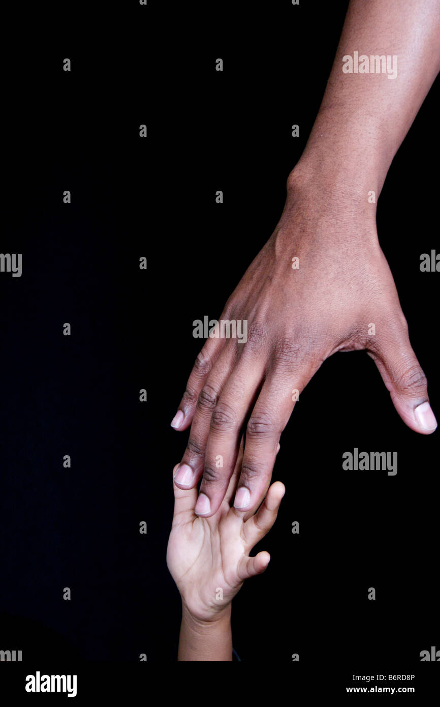 Father reaching for his son's extended hand Stock Photo - Alamy