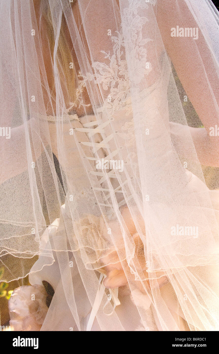 Back view of bride walking away from camera wearing intricate handmade ...