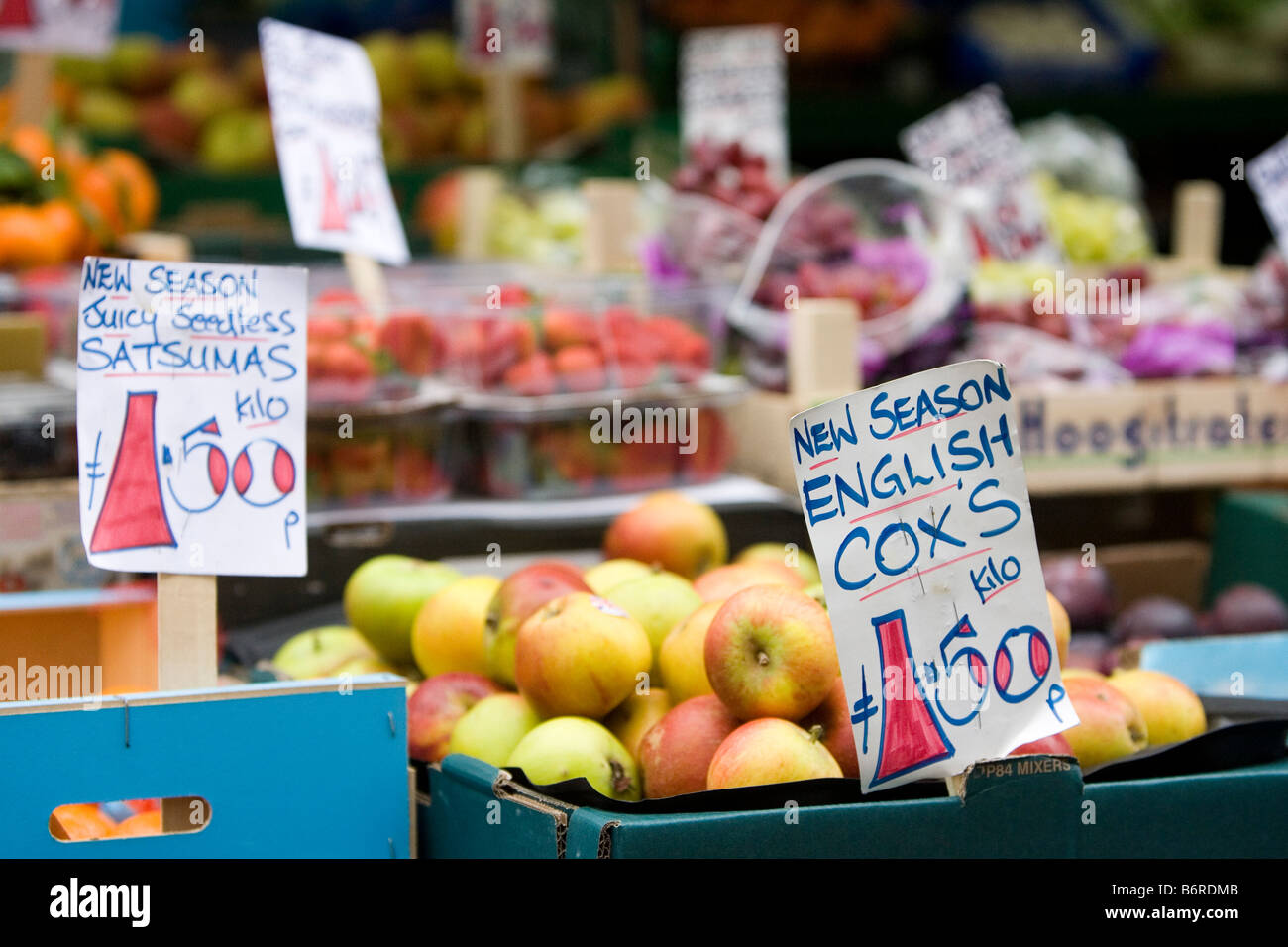 English cox apples and fresh vegetables and fruit on a market stall ...