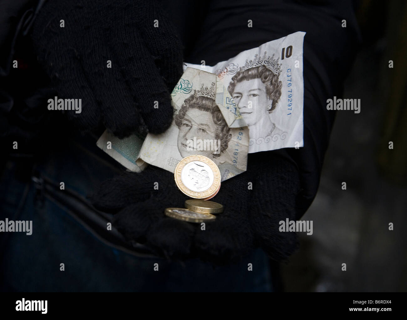 A market stall holder showing money 10 5 notes and coins on at a market ...