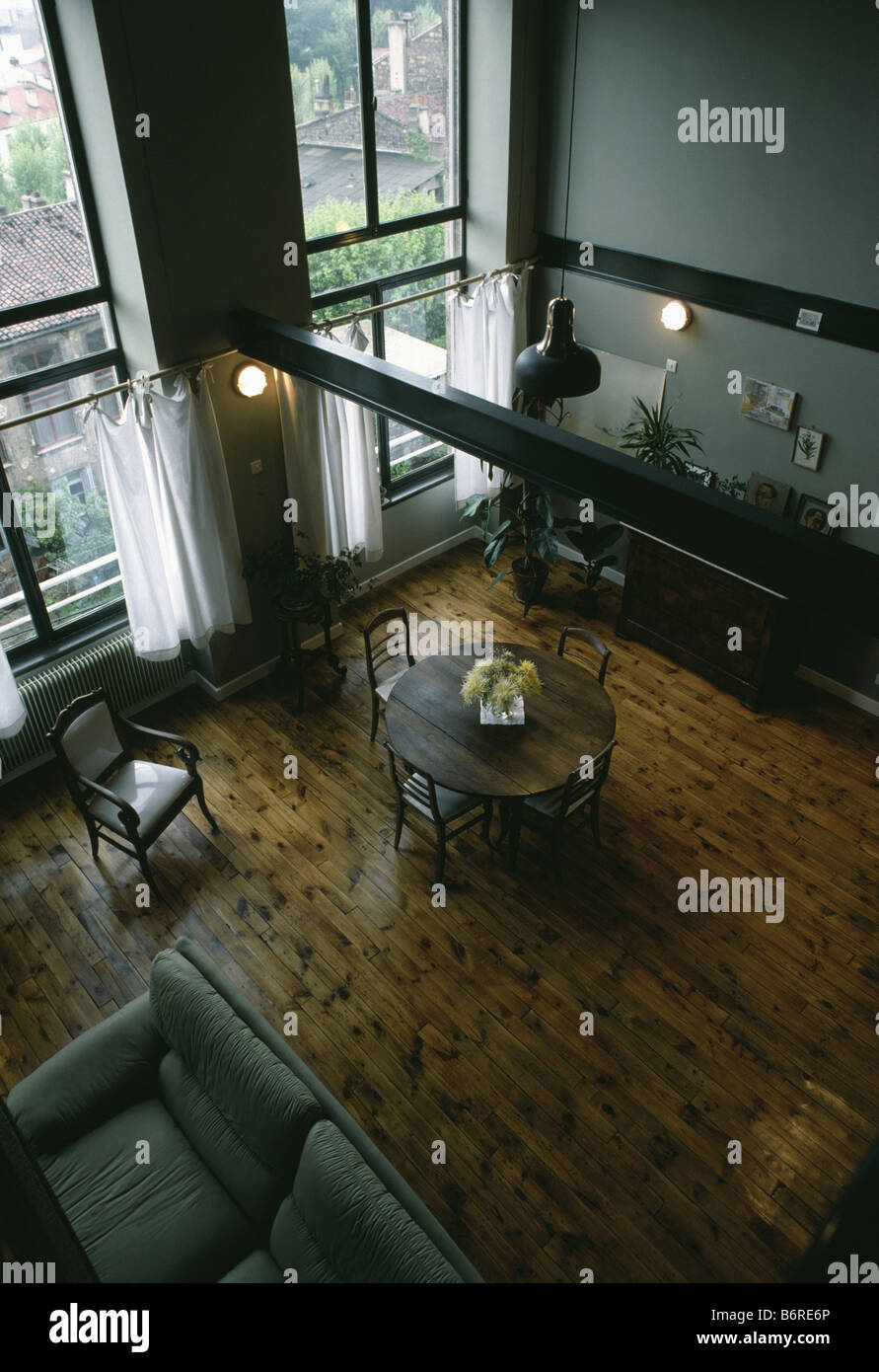 Birdseye view of double height dining room with circular table and ...