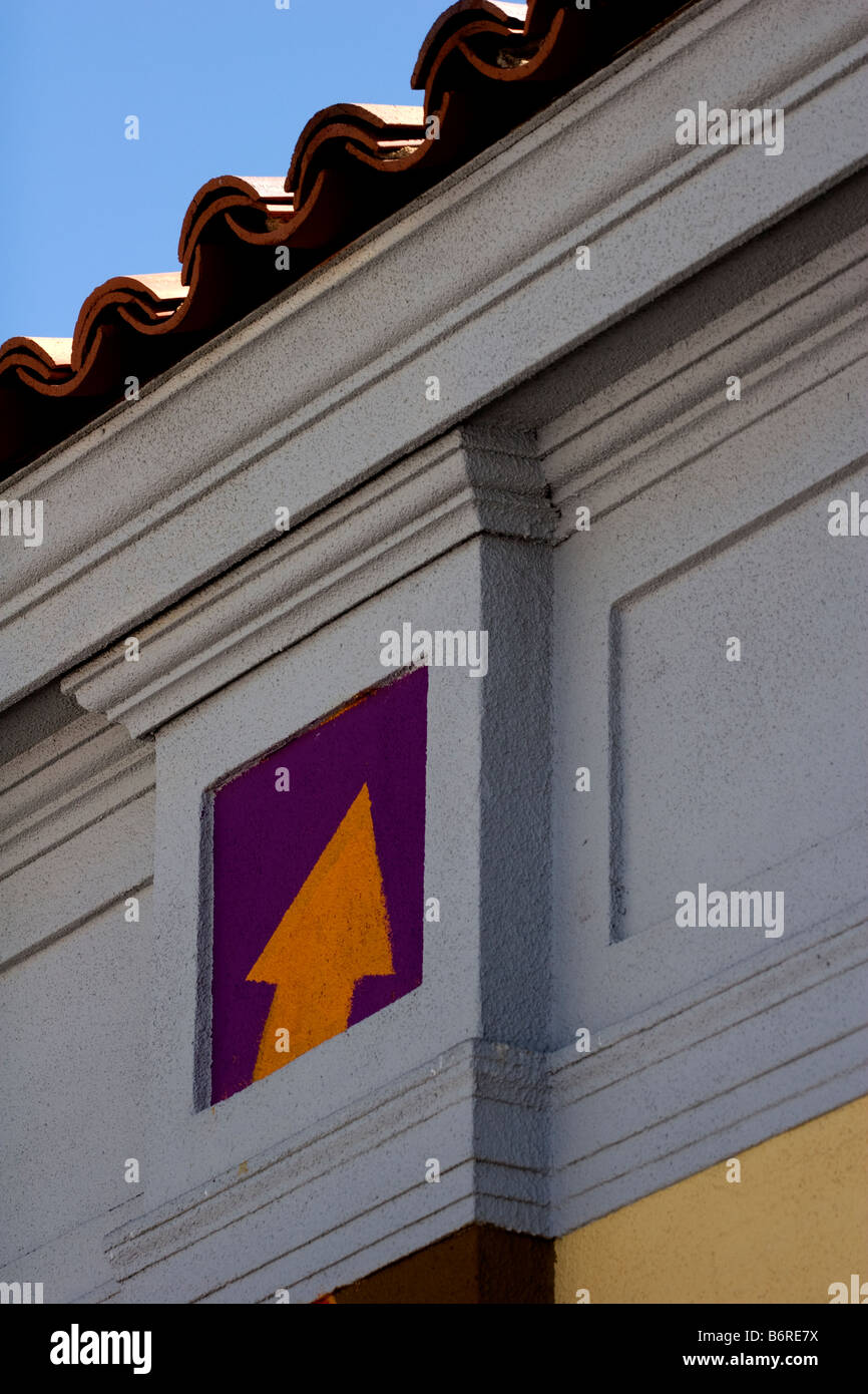 Arrow pointing upward on side of building Stock Photo - Alamy