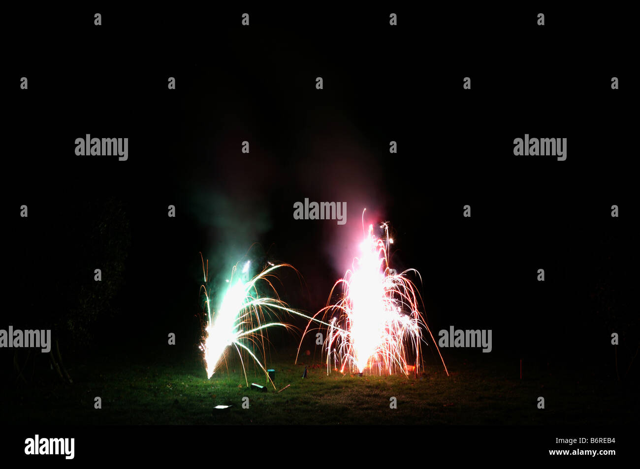 small family firework display in personal space on lawn in darkness in ...