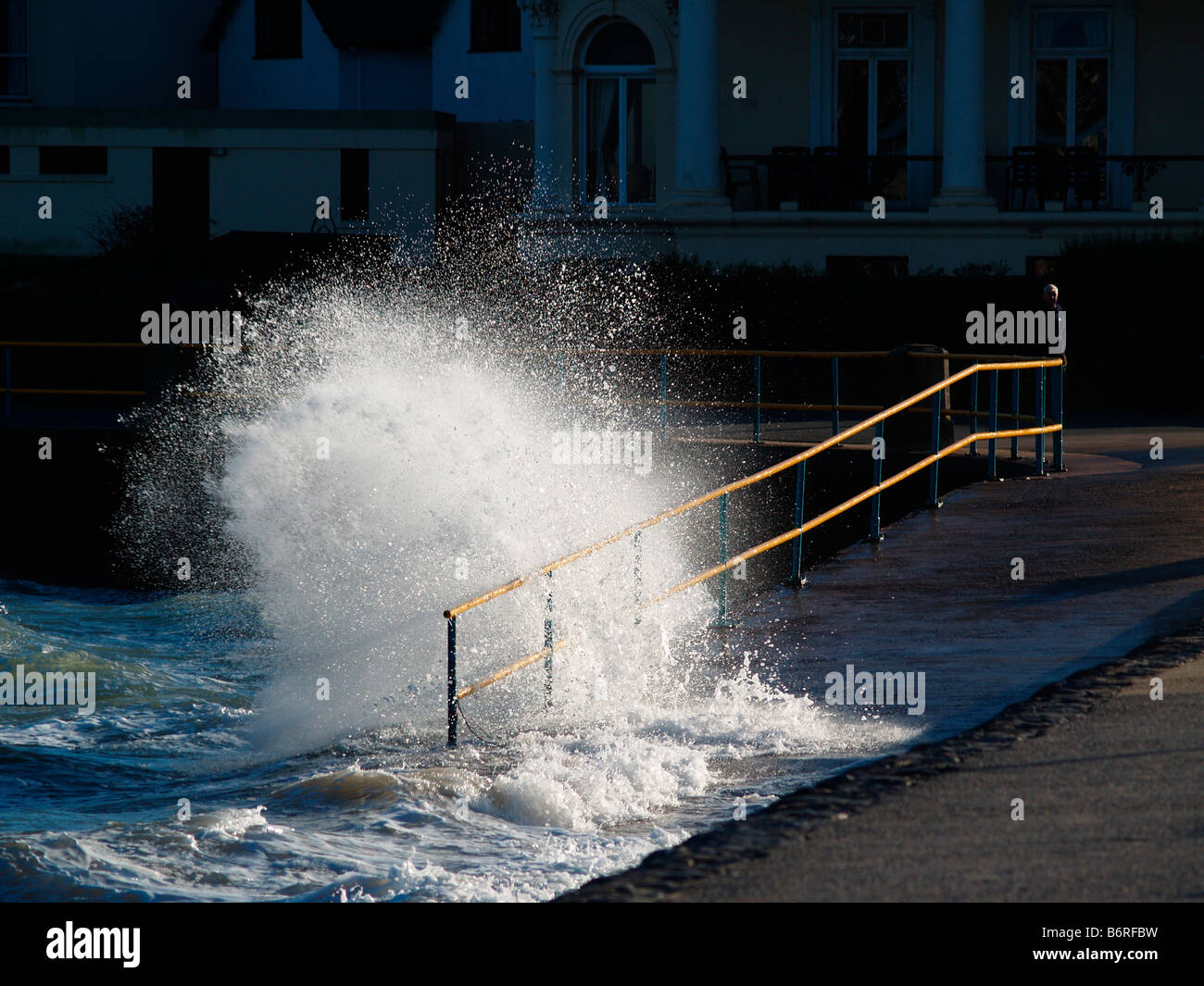 Crashing wave over railings on seafront Stock Photo - Alamy