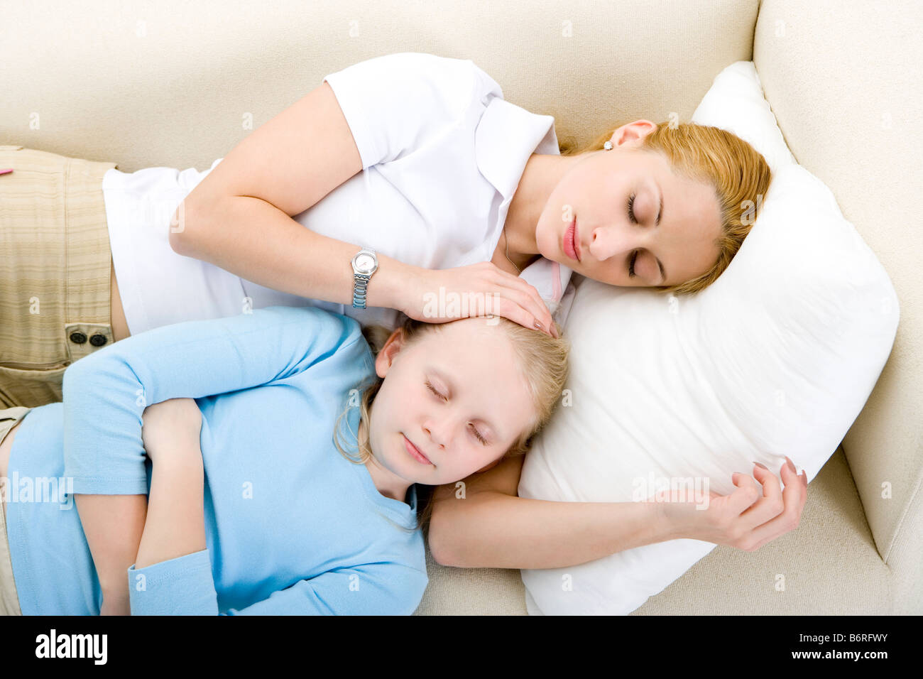 Mother and daughter sleeping on sofa portrait Stock Photo - Alamy