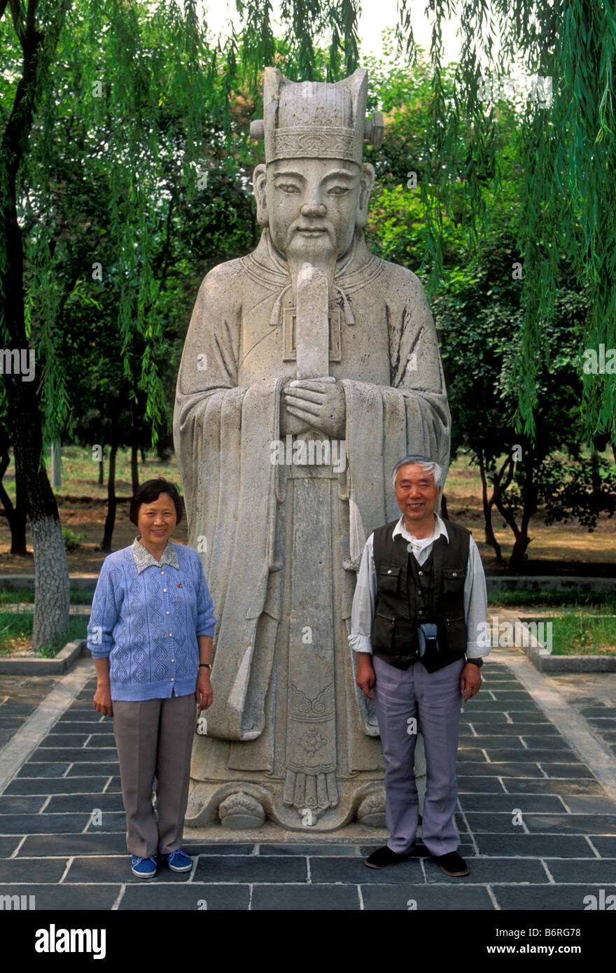 Chinese man and woman and stone statue of Civilian Mandarin along ...