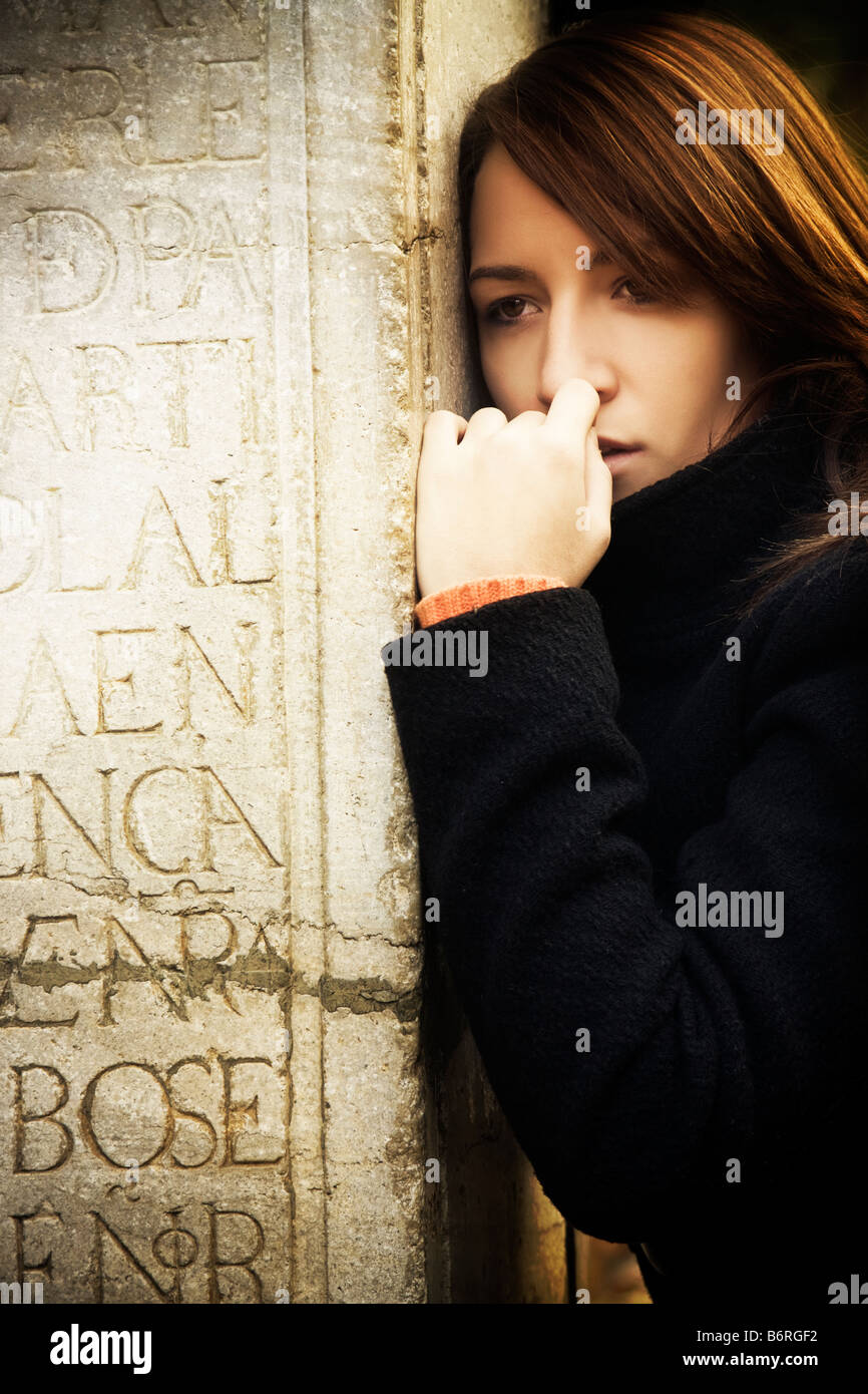 Sad woman embracing a grave Stock Photo - Alamy