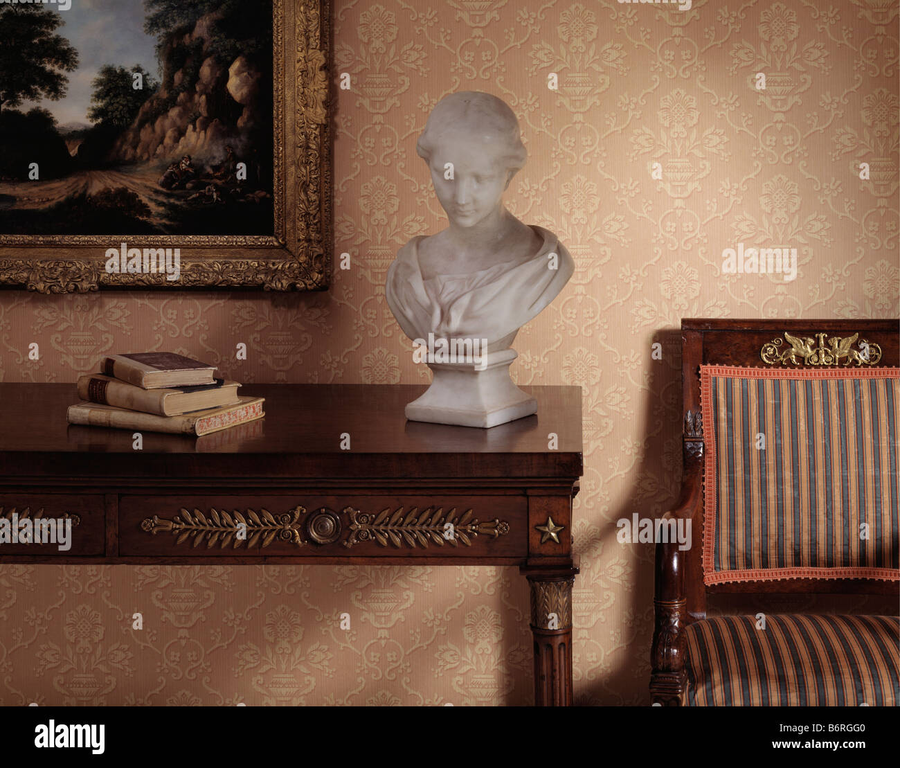 Close-up of classical bust on table in hall with neutral wallpaper ...