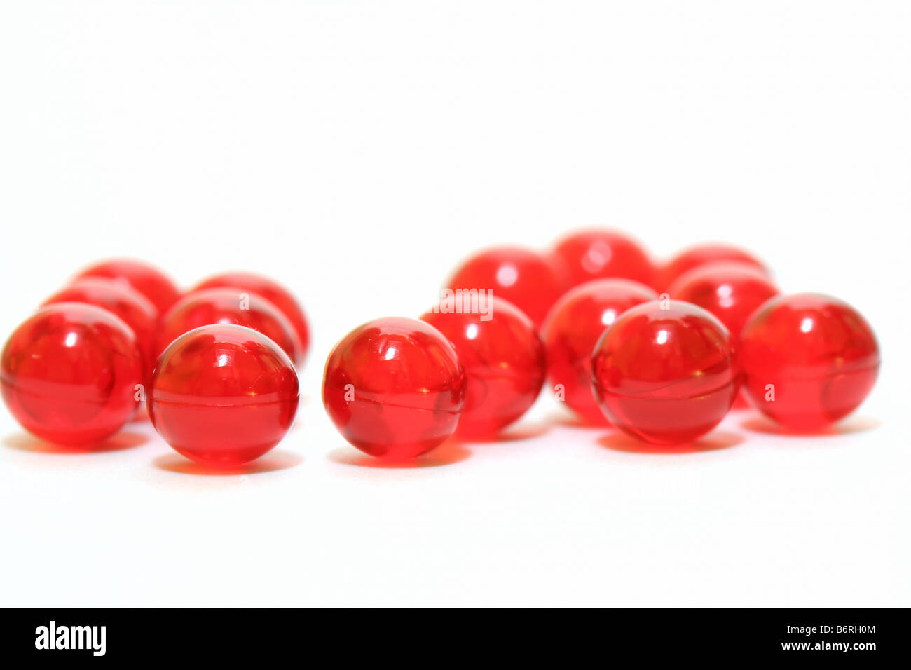 Pills on red background Cut Out Stock Images & Pictures - Alamy