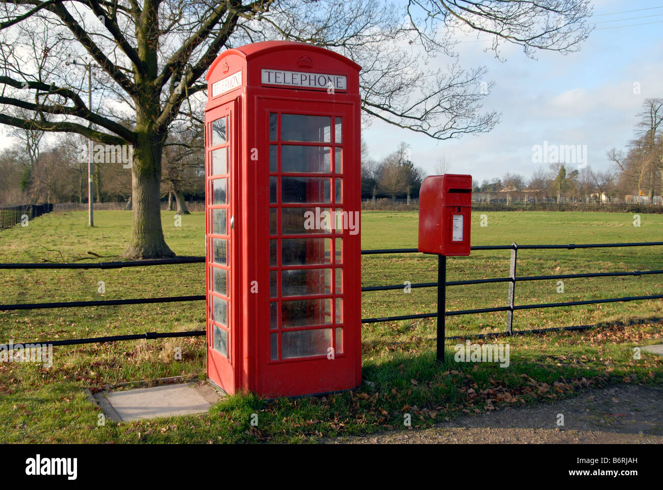Traditional red phone box and post box next to each other ...
