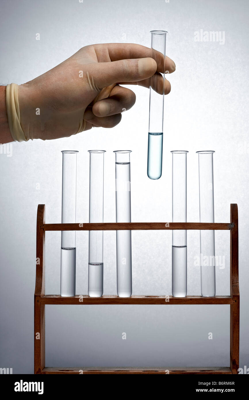 Gloved hand holding test tubes hi-res stock photography and images - Alamy