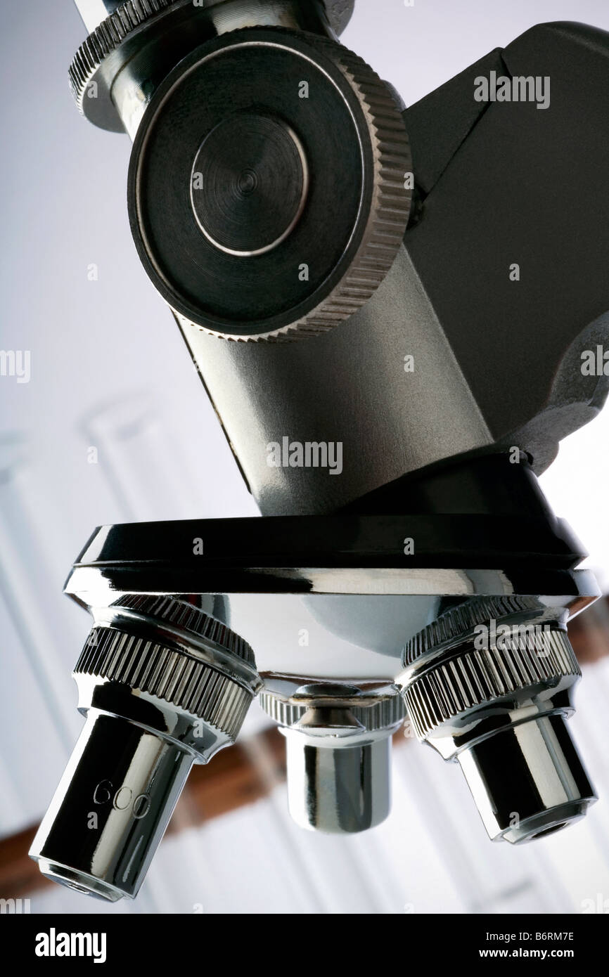 detail of a microscope with test tubes in the back Stock Photo - Alamy