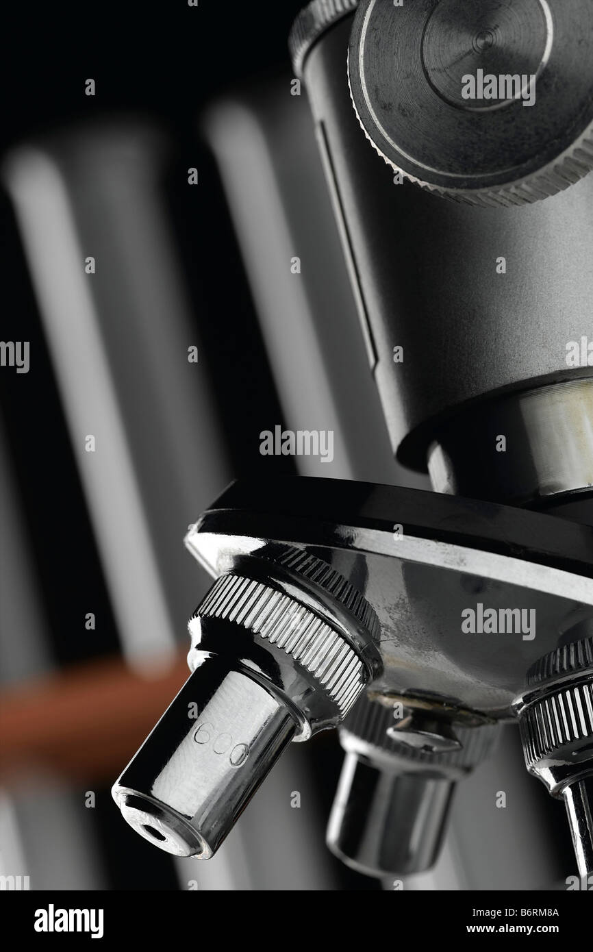 detail of a microscope with test tubes in the back Stock Photo - Alamy
