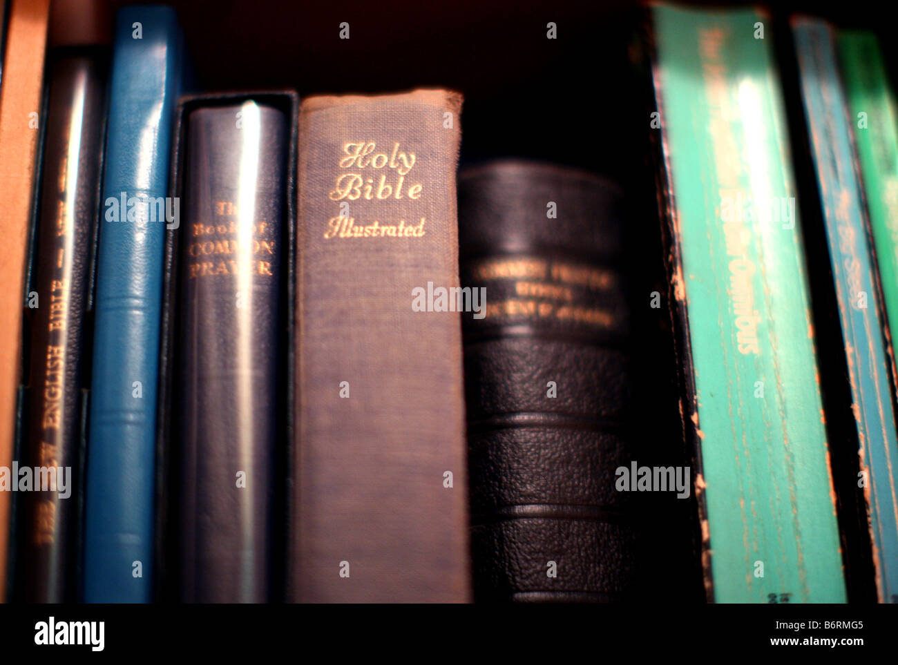 Holy Bible and other books on shelf Stock Photo - Alamy