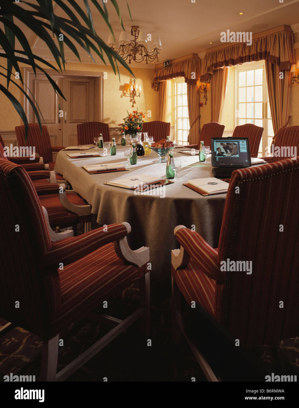 Menus and brown cloth on long table in private restaurant dining room ...