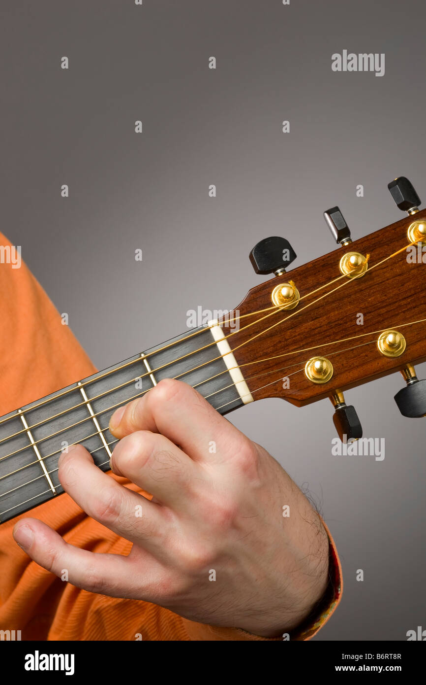 Close up of acoustic guitar players left hand Stock Photo - Alamy
