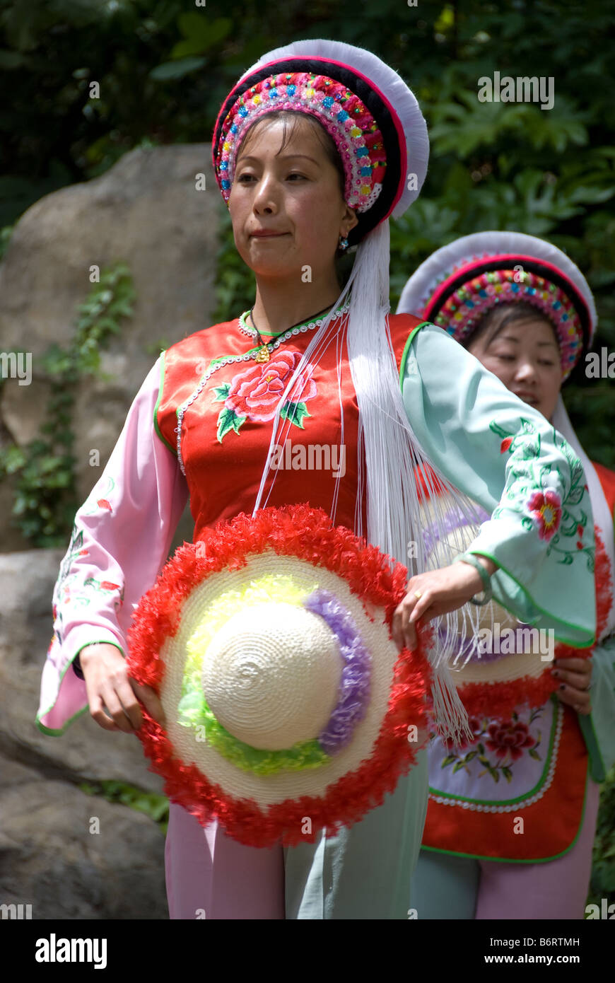 Two female Dai dancers wearing traditional costume with headdress and ...