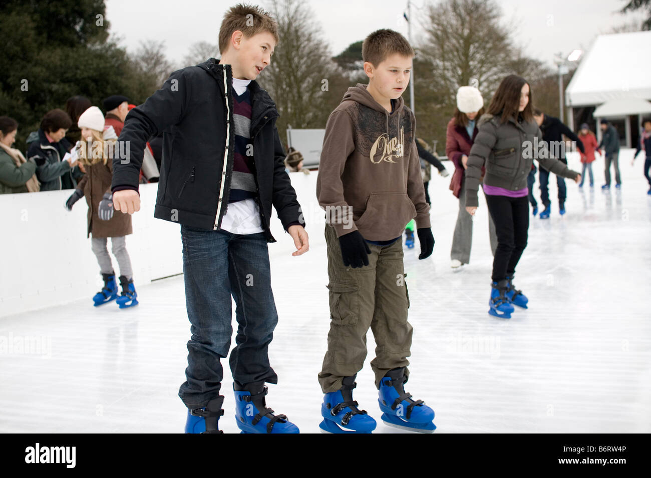 Two boys learning to skate Stock Photo - Alamy