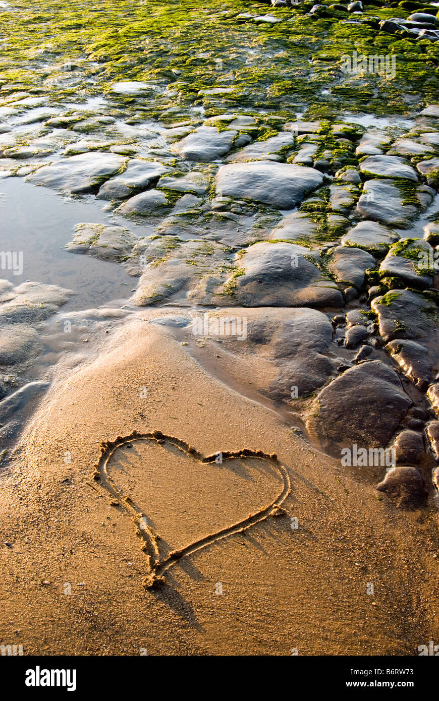 Heart shape rocks beach sand hi-res stock photography and images - Alamy