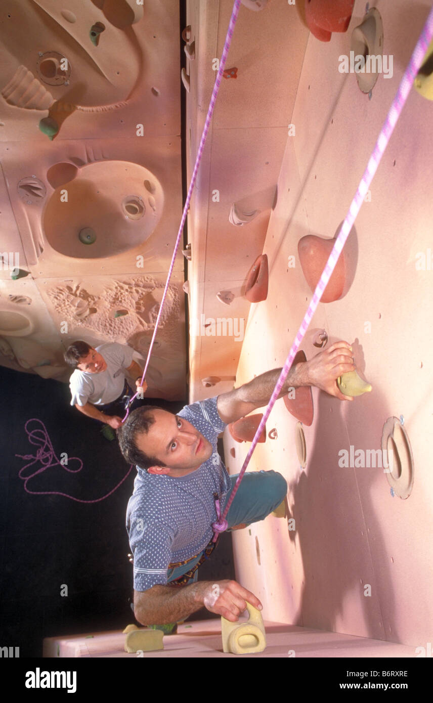 Climbers training on indoor artificial climbing wall Stock Photo - Alamy