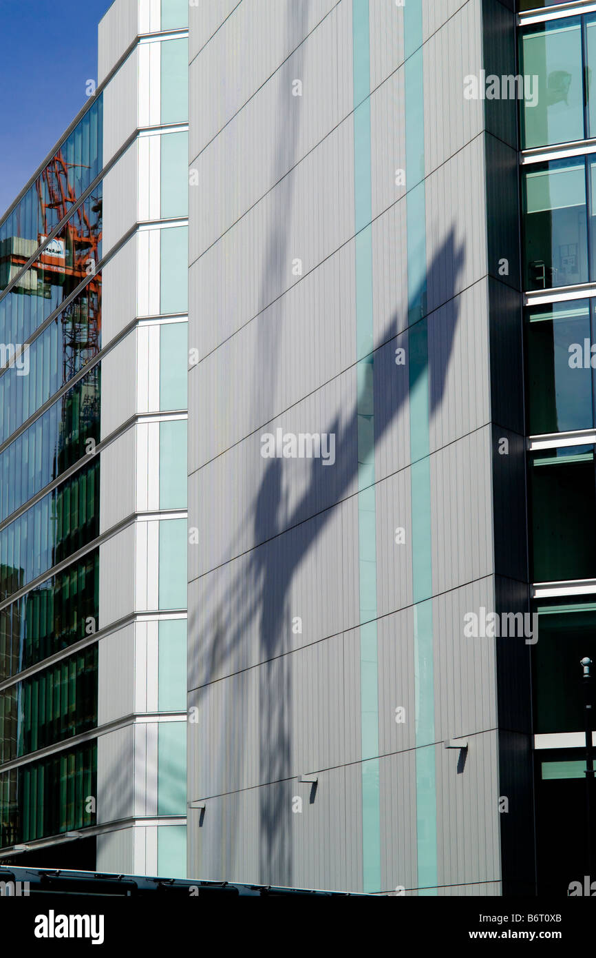 Shadow of a crane on a modern built commercial office building Stock ...