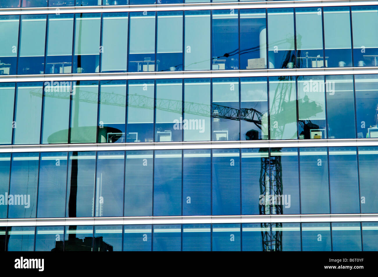 Shadow of a crane on a modern built commercial office building Stock ...
