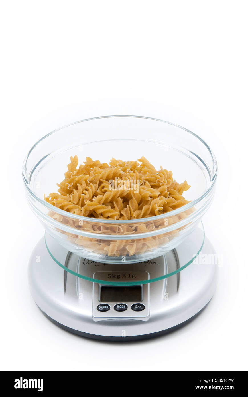 bowl of dried pasta being weighed on a set of scales Stock Photo - Alamy