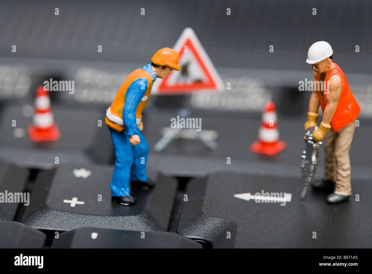 Miniature figures working on a computer keyboard Stock Photo - Alamy
