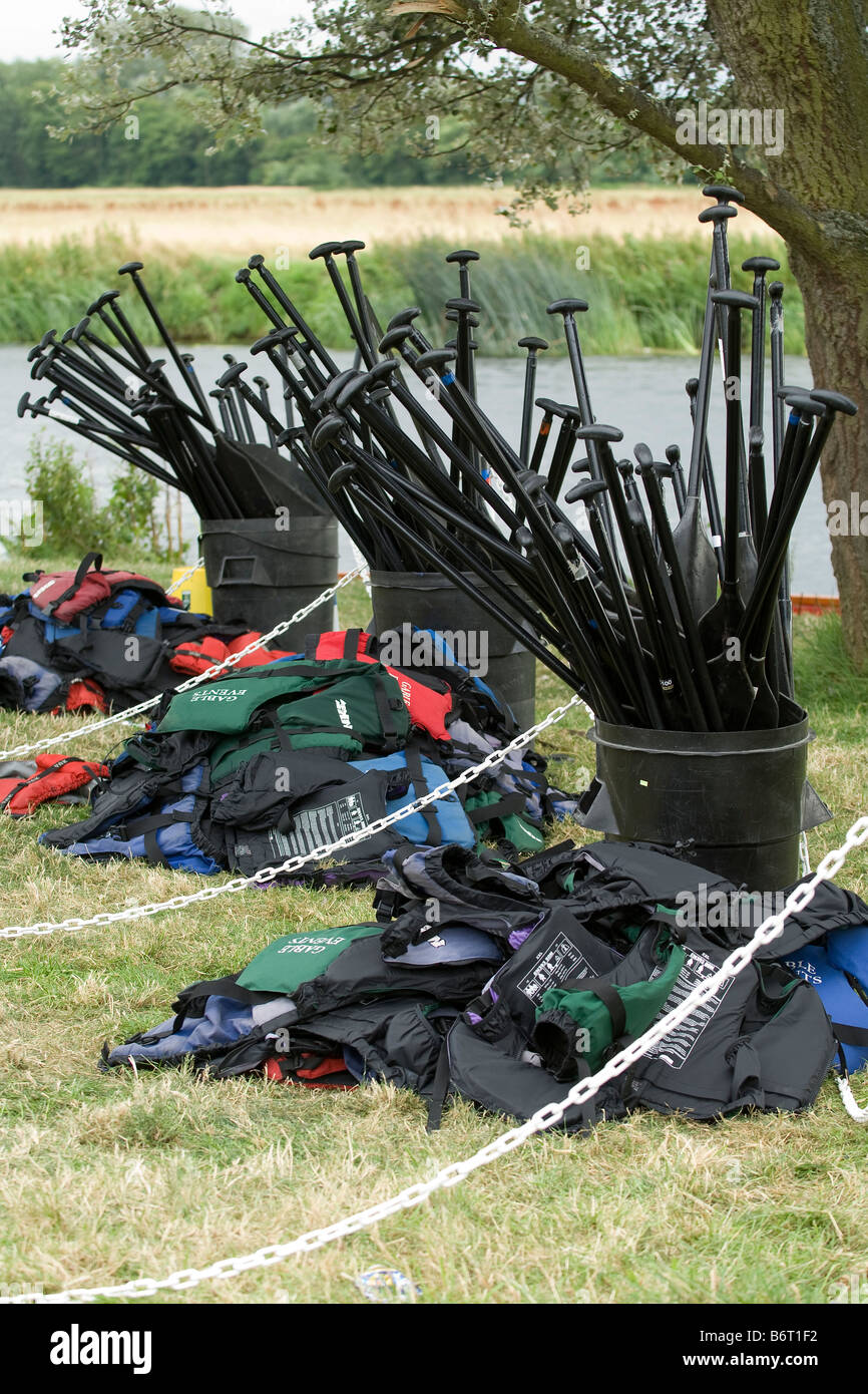 Dragon boat oars and life jackets Stock Photo - Alamy