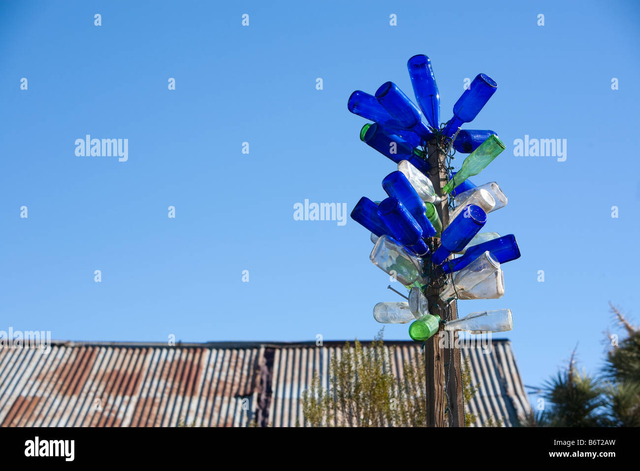 An artist's creation of a sculpture made from old glass bottles is ...
