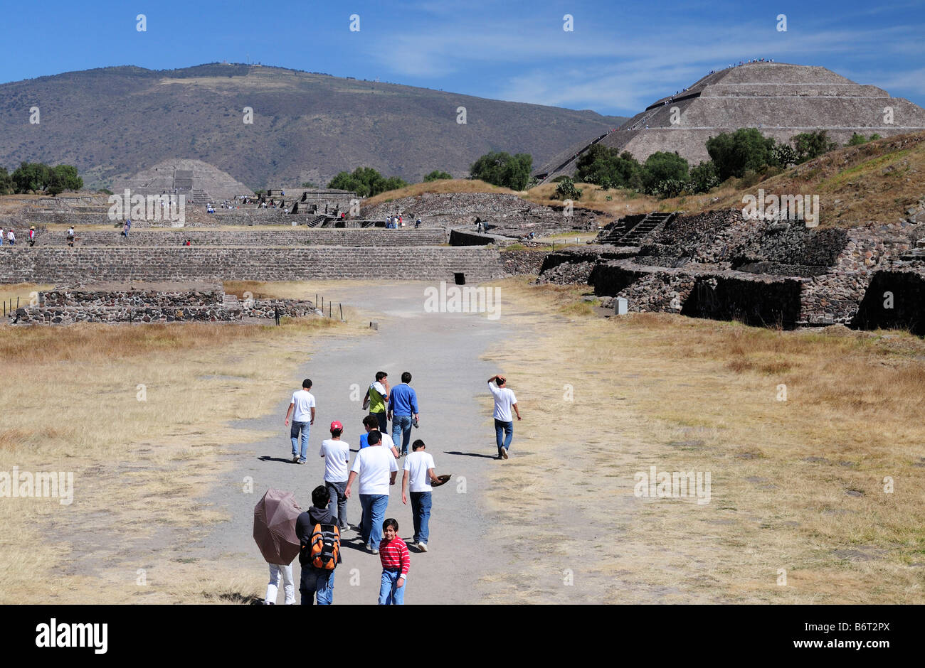 Tourists walking down Calzada de los Muertos Causeway of the Dead ...