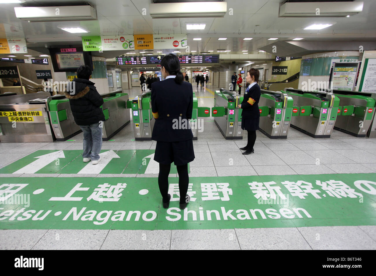 A sign on the floor giving directions to the Shinkansen Bullet train in ...