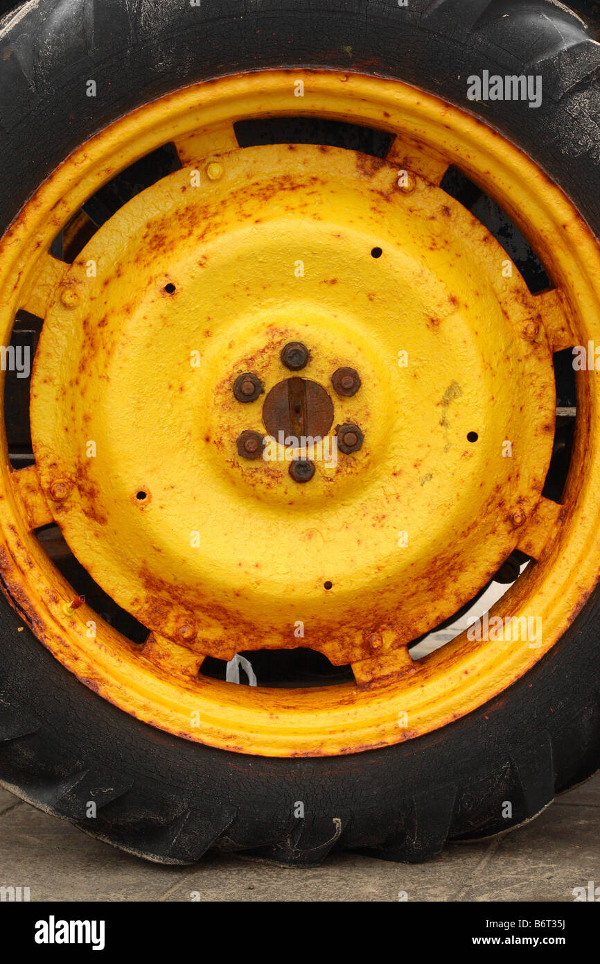 Yellow painted tractor wheel with rust used to pull fishing boats into ...