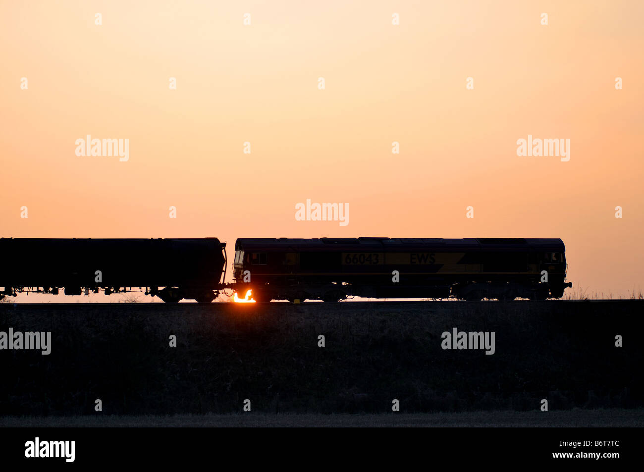 EWS class 66 diesel locomotive pulling oil train at sunset, UK Stock ...