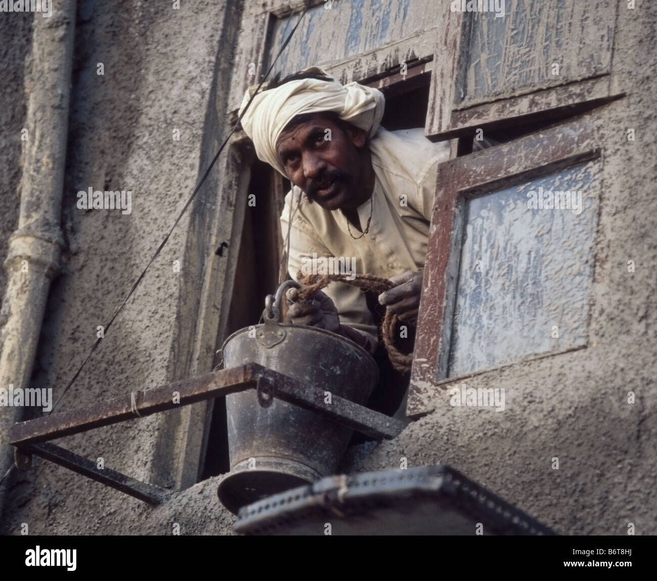 A construction worker looking out of a window in Delhi, India Stock ...