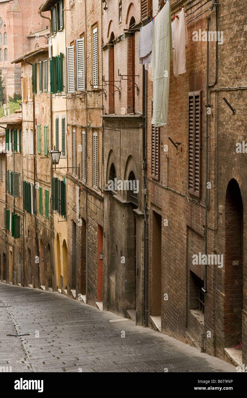 Typical Italian city backstreet in pastel colour buildings with washing ...