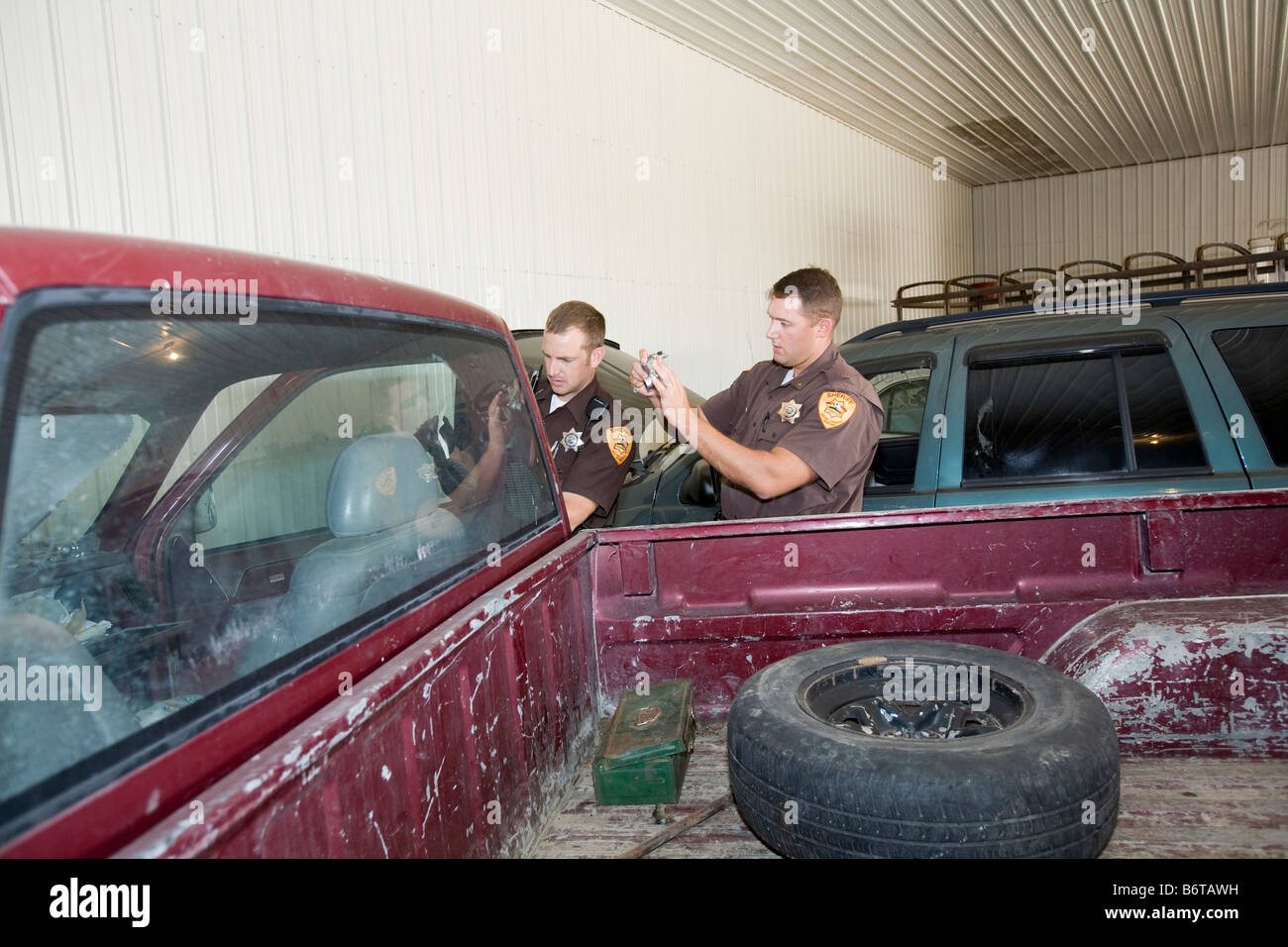 Deputy sheriffs searching vehicle for narcotics. Photographing to ...