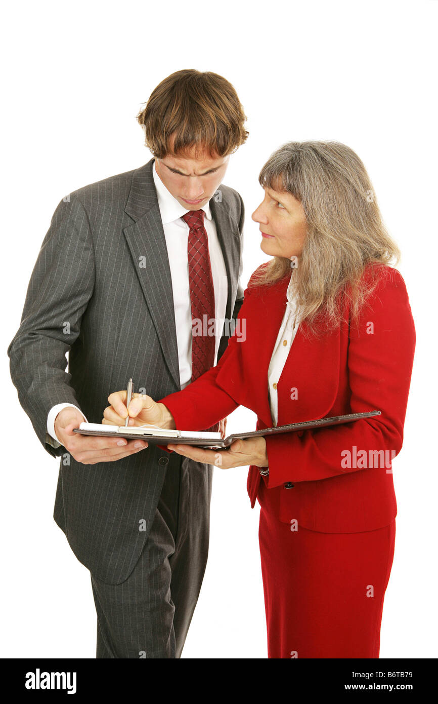 Mature female boss giving a poor performance review to a young male ...