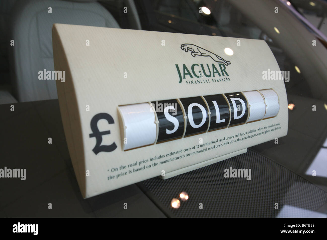 Sold sign in a Jaguar car showroom Stock Photo - Alamy