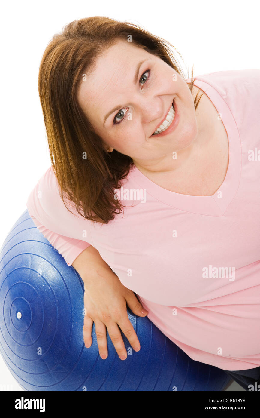 Beautiful plus sized woman resting on her pilates ball White background ...