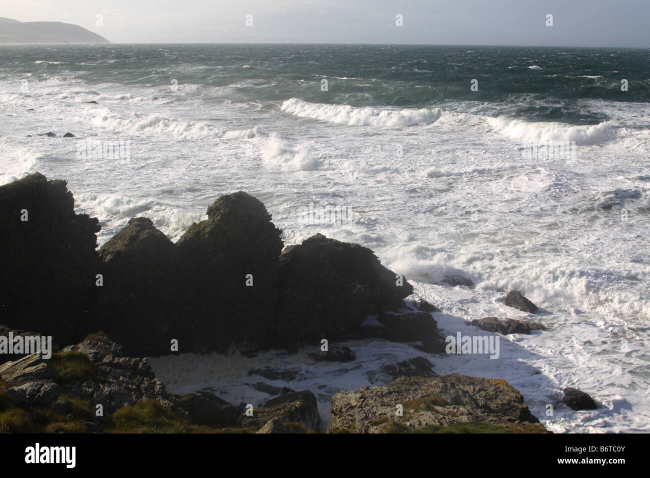 Waves breaking on rocky shore Stock Photo - Alamy