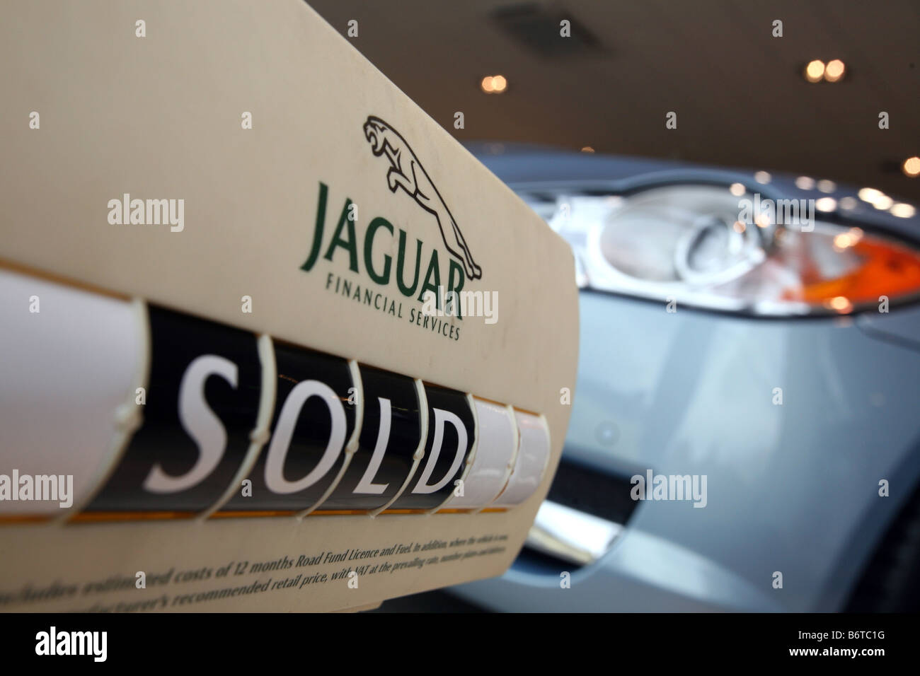 Sold sign in a Jaguar car showroom Stock Photo - Alamy