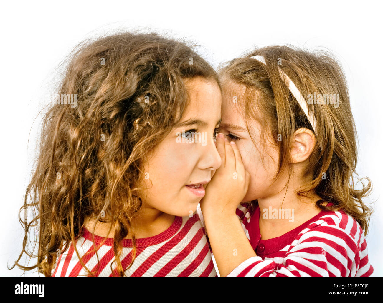 two girls telling a secret Stock Photo - Alamy