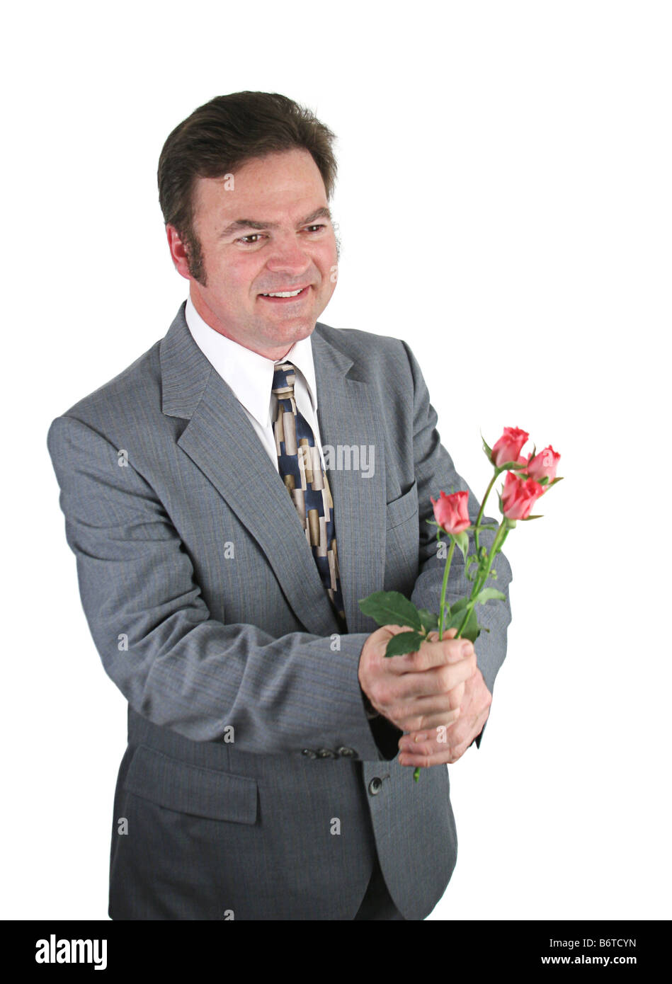 A handsome man in a suit bringing roses for his date Stock Photo - Alamy