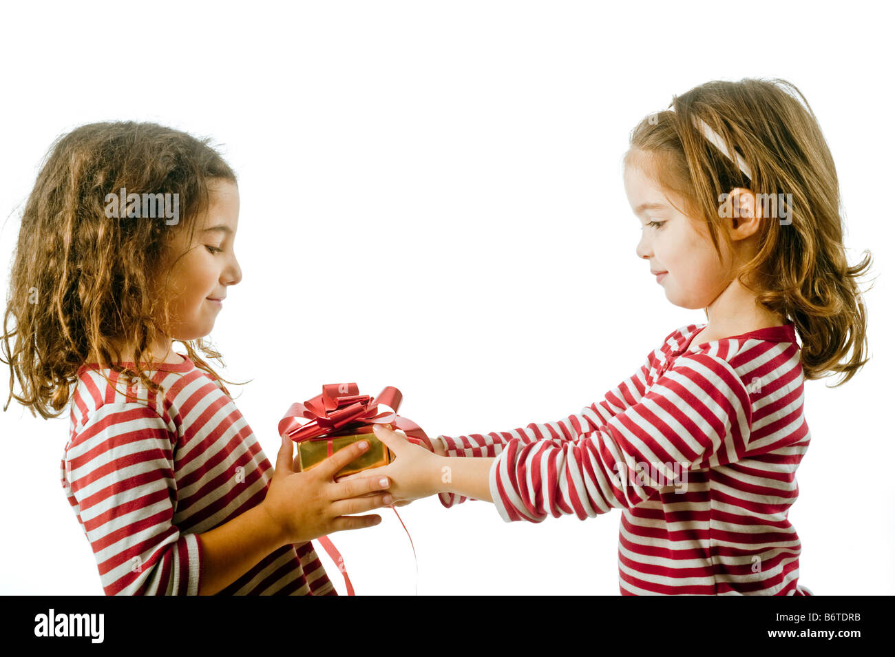 two little girls giving a present isolated on white Stock Photo - Alamy