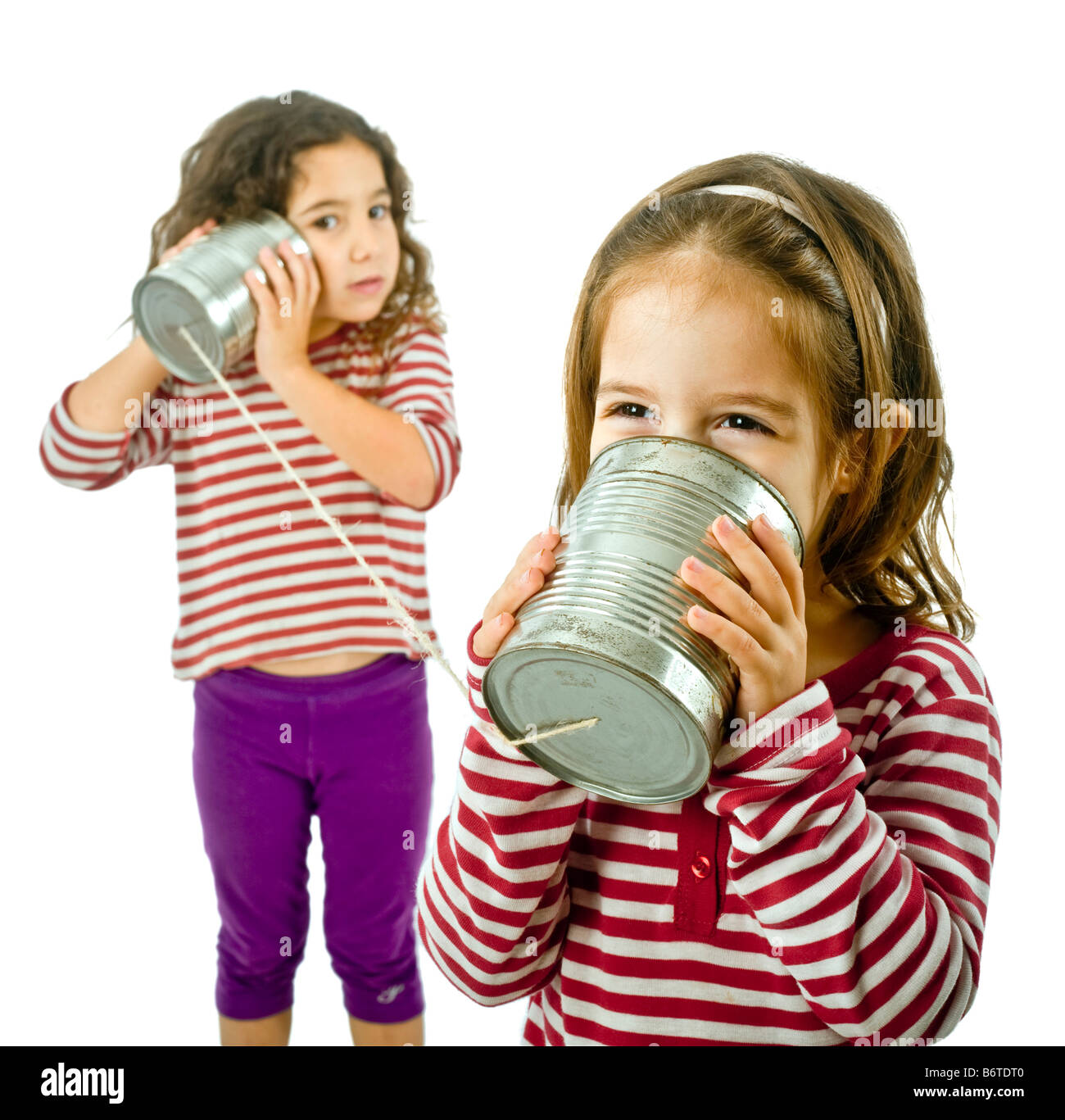 two girls talking on a tin phone isolated on white Stock Photo - Alamy