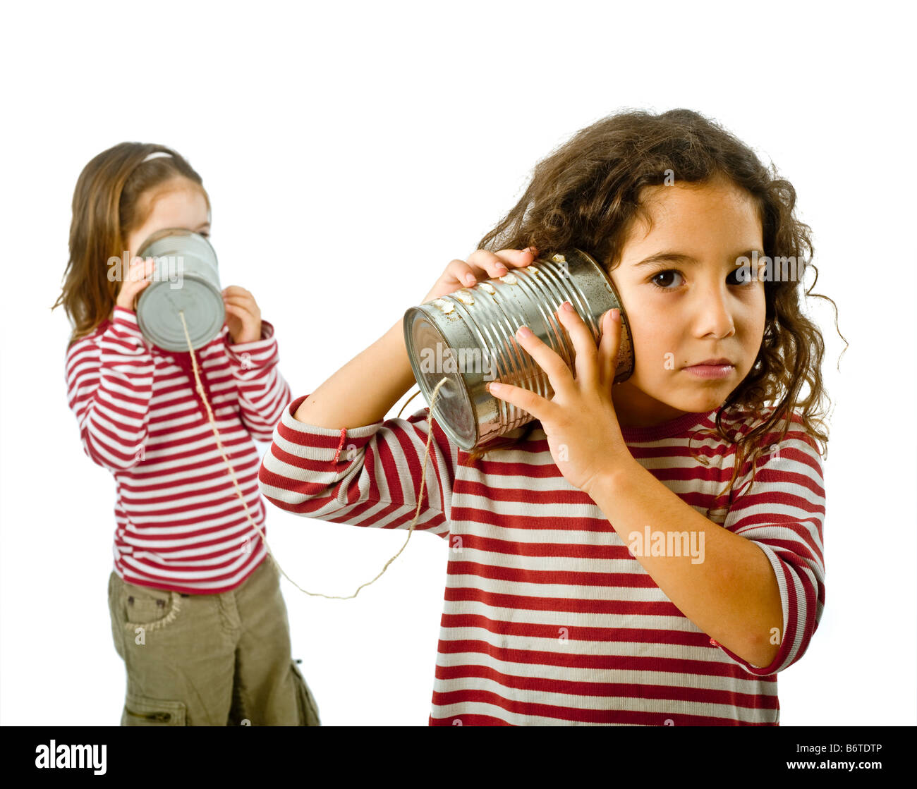 two girls talking on a tin phone isolated on white Stock Photo - Alamy