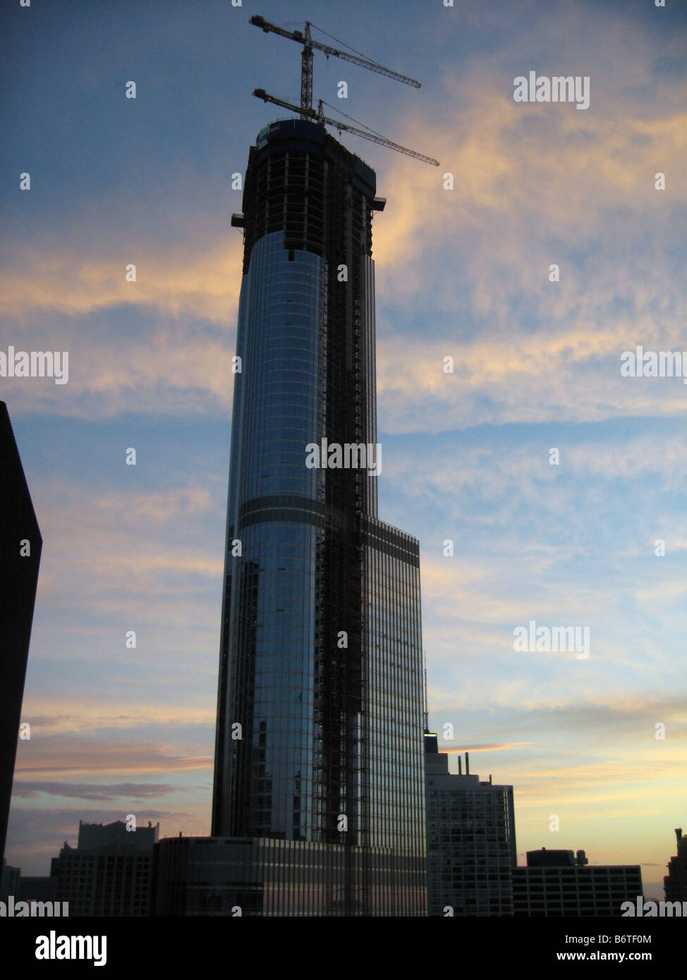Modern Skyscraper Construction Against A Vibrant Sunset Sky Stock Photo ...